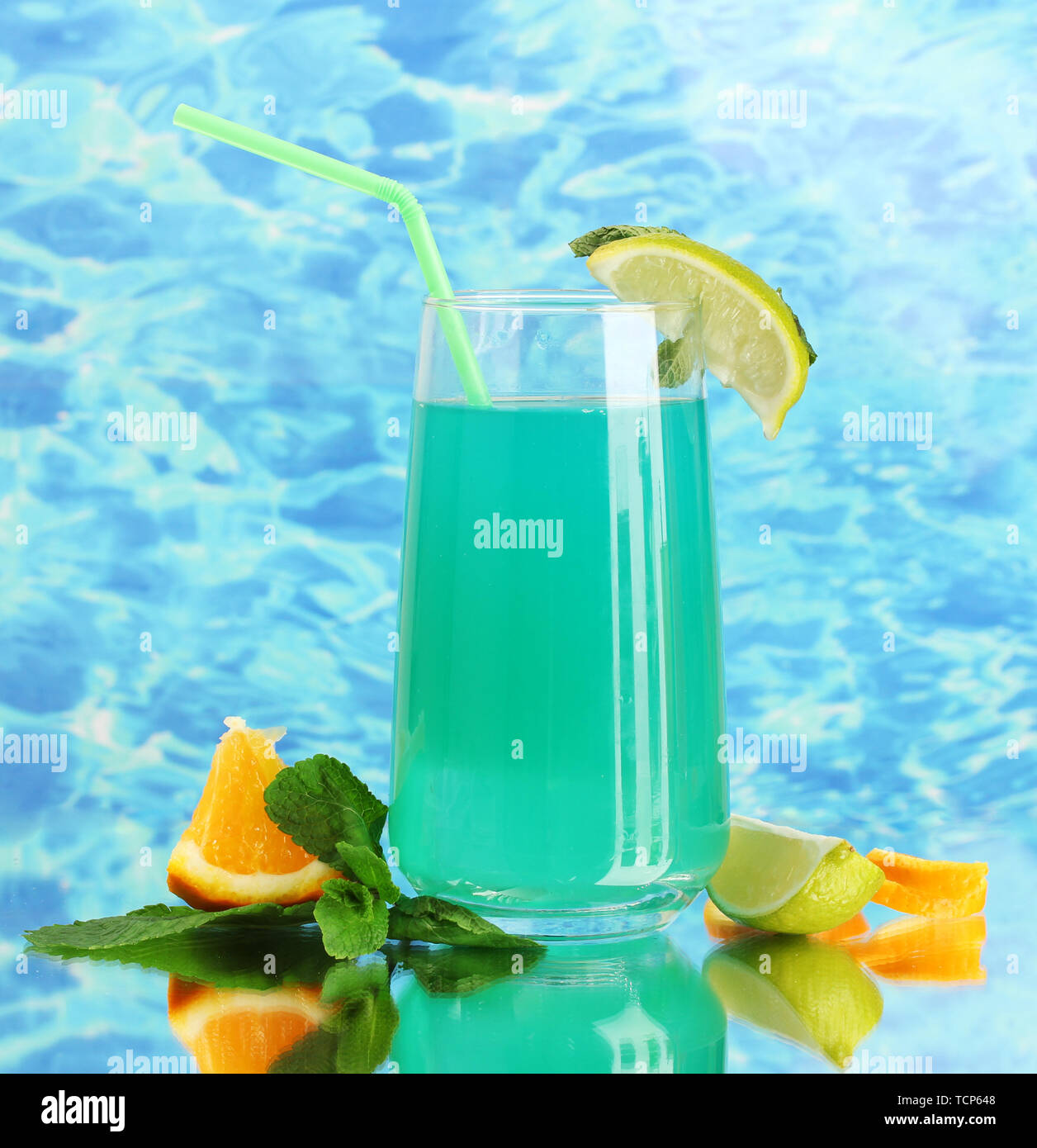 Glass of blue cocktail on blue background Stock Photo - Alamy