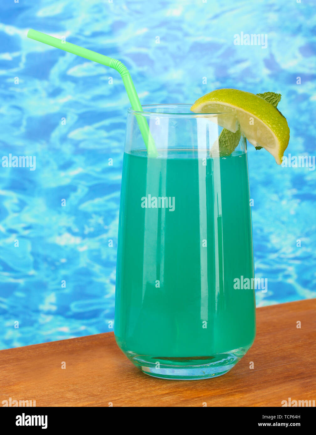 Glass of blue cocktail on blue background Stock Photo - Alamy