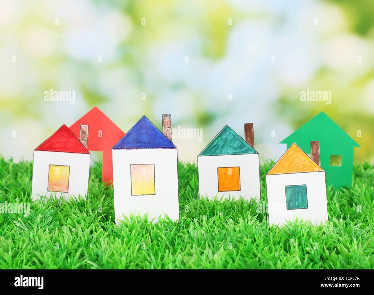 paper houses on green background, close up Stock Photo - Alamy
