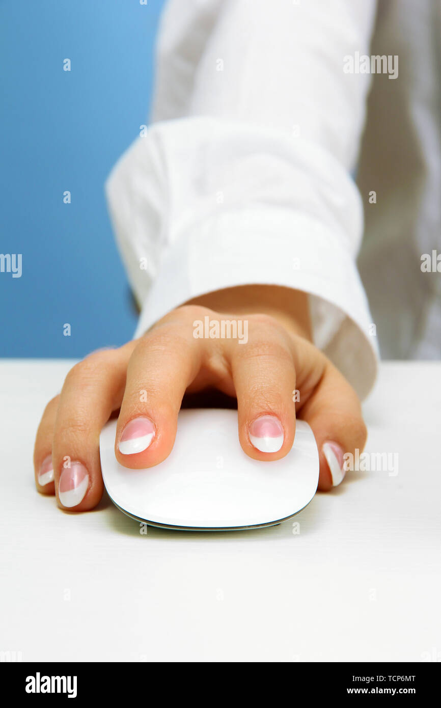 female hand pushing keys of pc mouse, on blue background Stock Photo ...