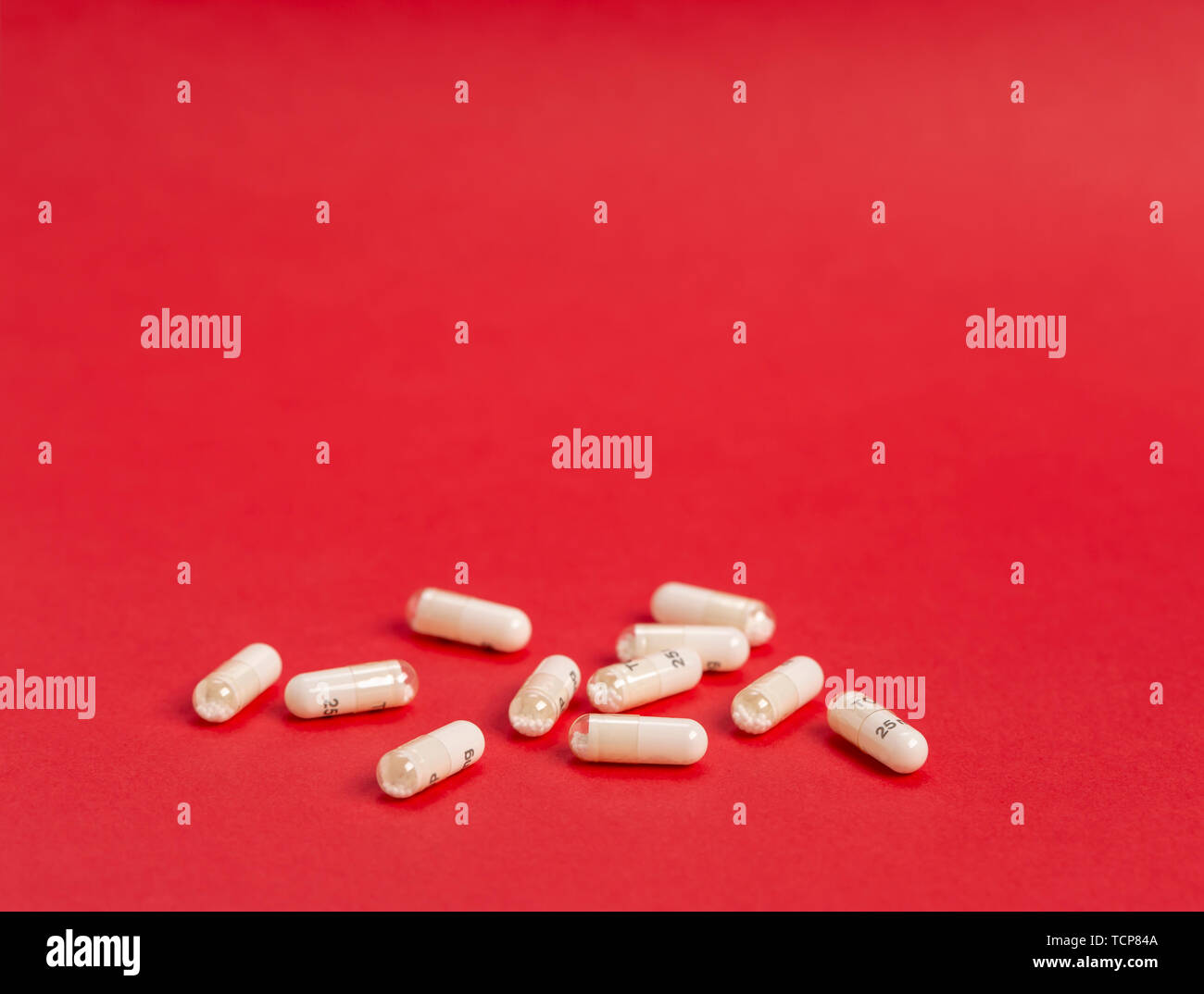 Variety of white capsules on a colored background Stock Photo - Alamy