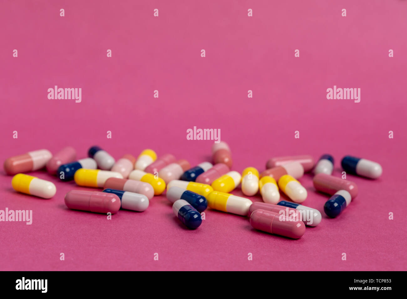 Various colored medical capsules with white microgranules Stock Photo ...