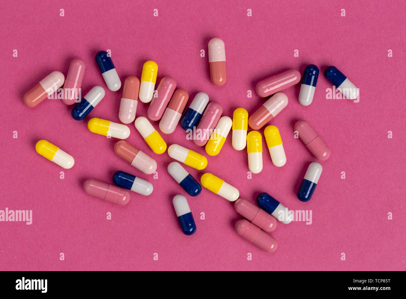 Various colored medical capsules with white microgranules Stock Photo ...