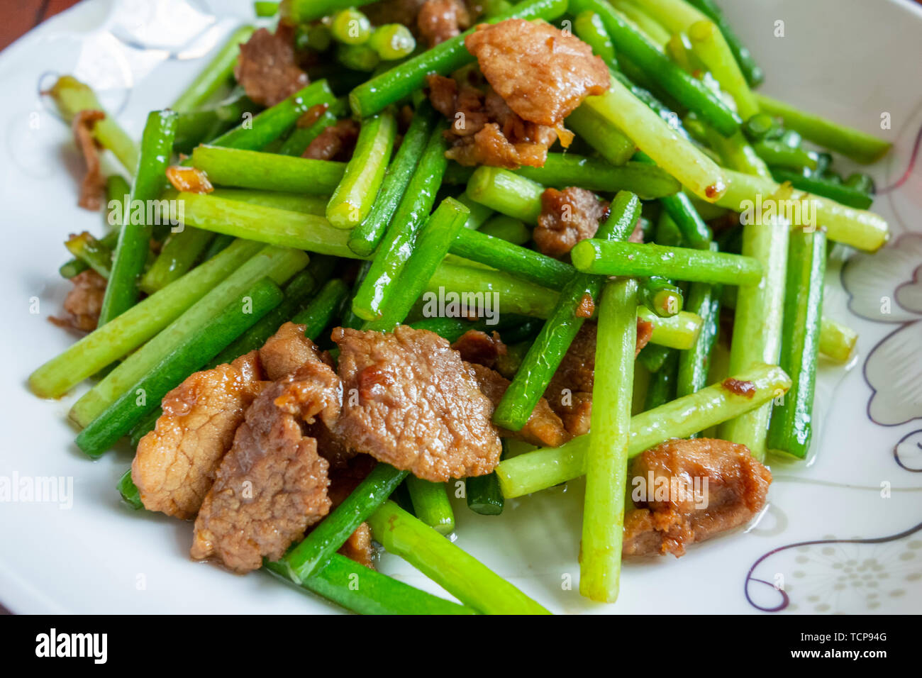 Home-cooked garlic moss fried meat Stock Photo - Alamy