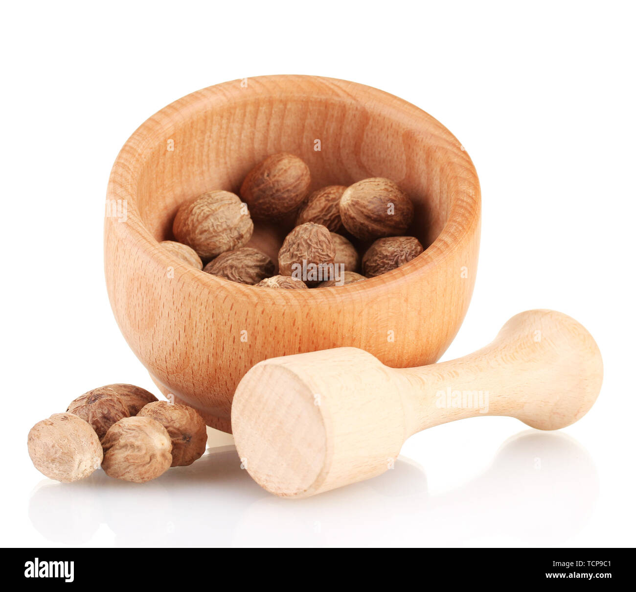 nutmeg in wooden mortar isolated on white Stock Photo - Alamy