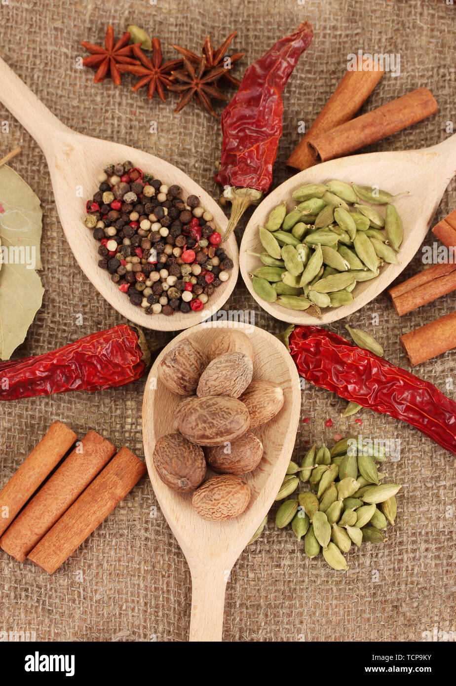 Nutmeg and other spices on sackcloth background Stock Photo - Alamy