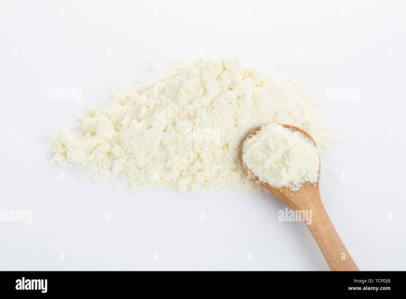 A wooden spoon and milk powder on a white background Stock Photo - Alamy
