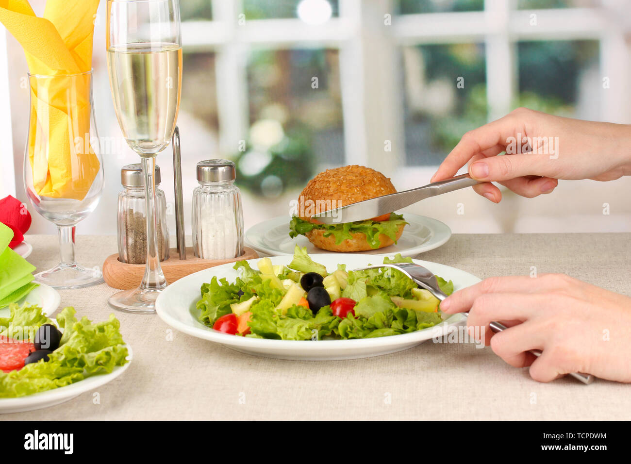 Female hand with dinner on bright background Stock Photo - Alamy