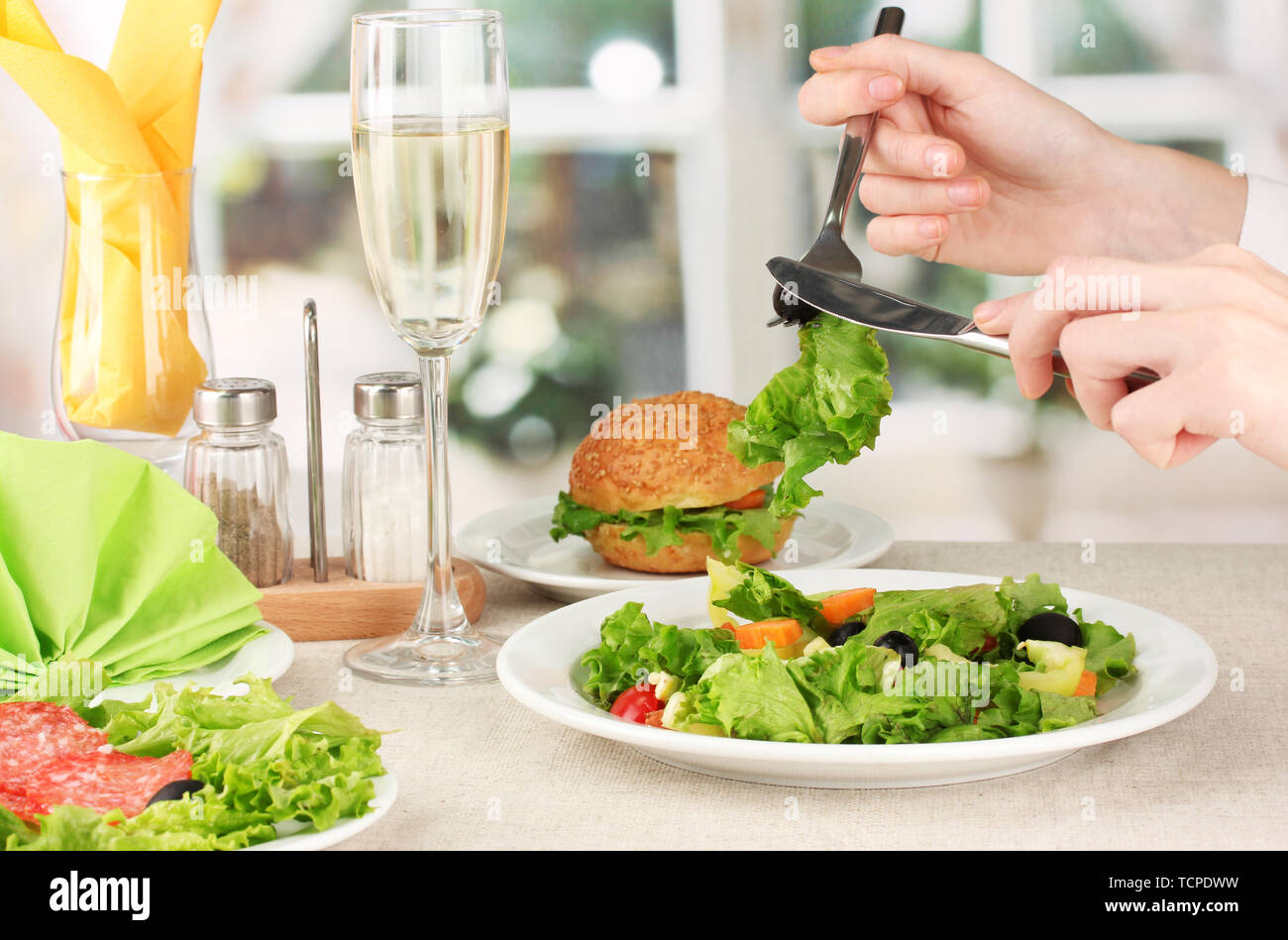 Female hand with dinner on bright background Stock Photo - Alamy