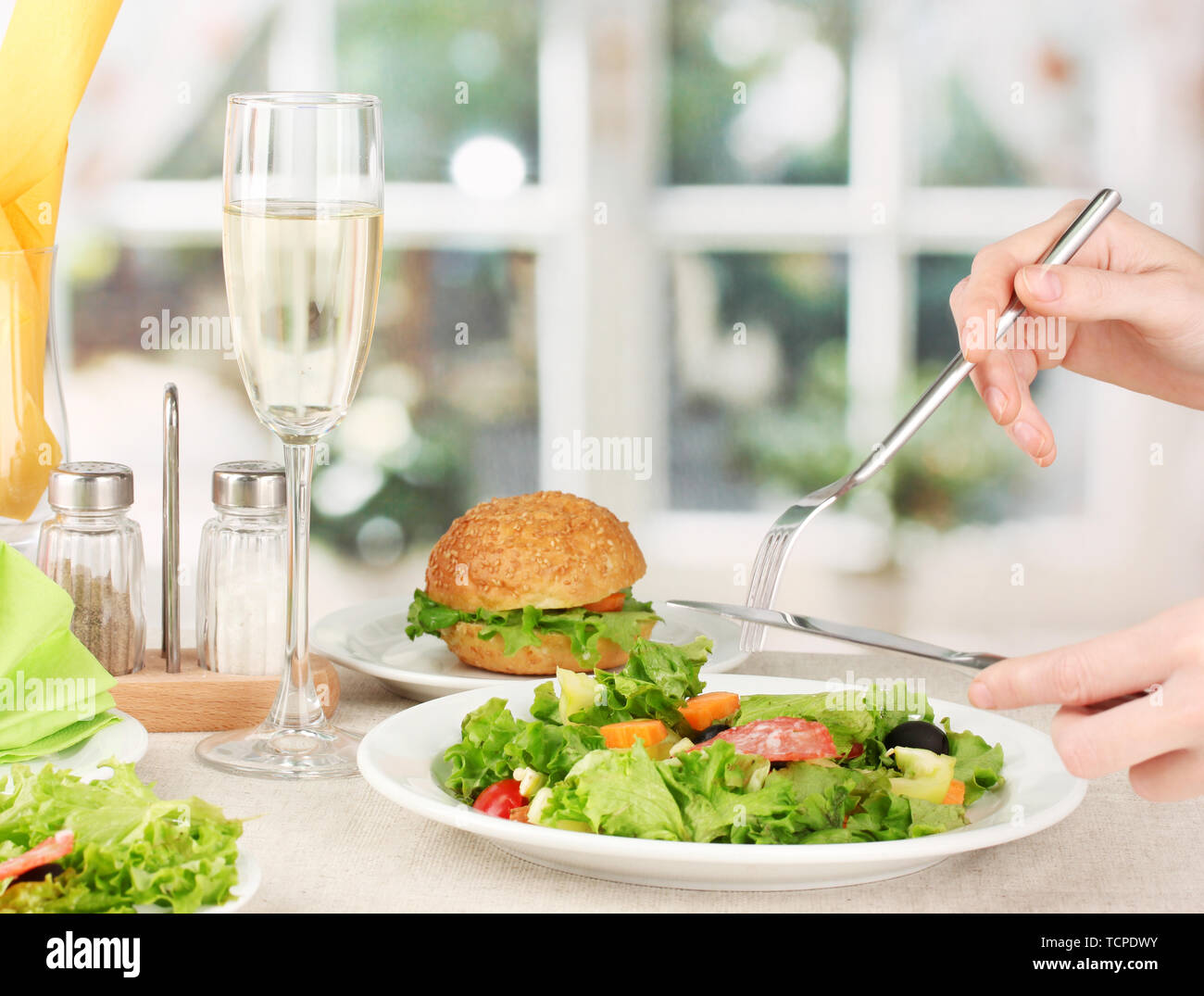 Female hand with dinner on bright background Stock Photo - Alamy