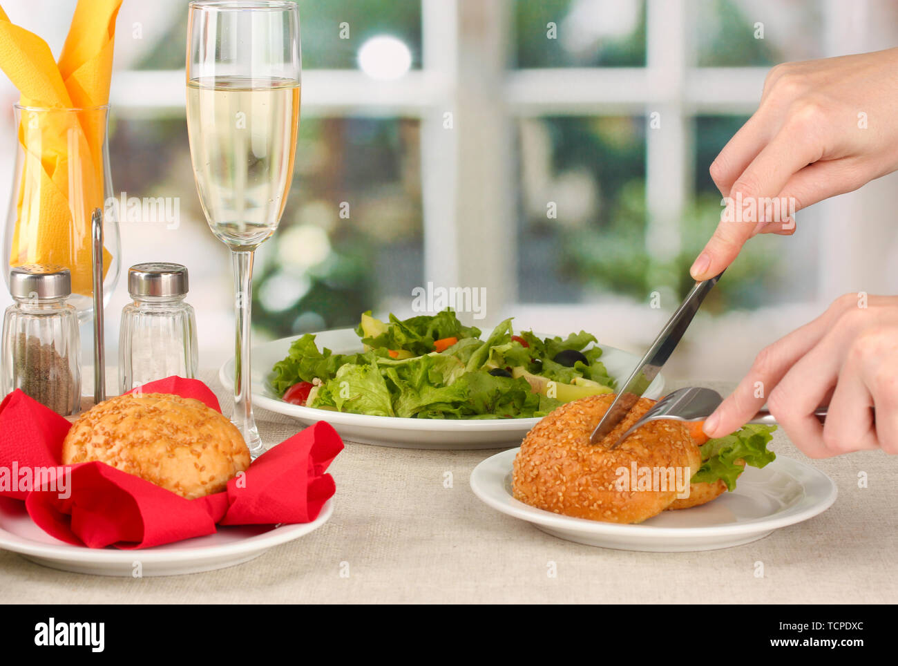 Female hand with dinner on bright background Stock Photo - Alamy