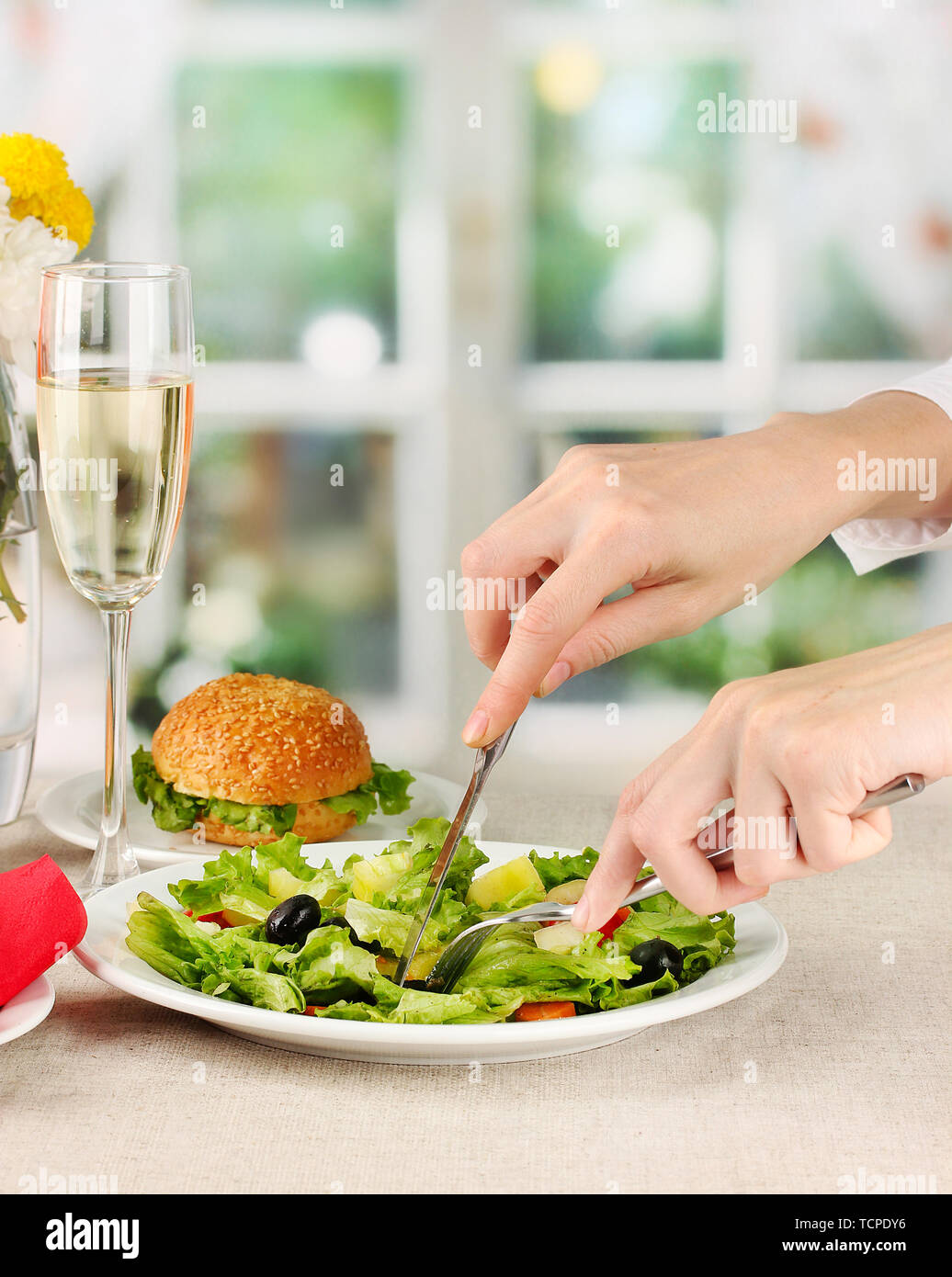 Female hand with dinner on bright background Stock Photo - Alamy