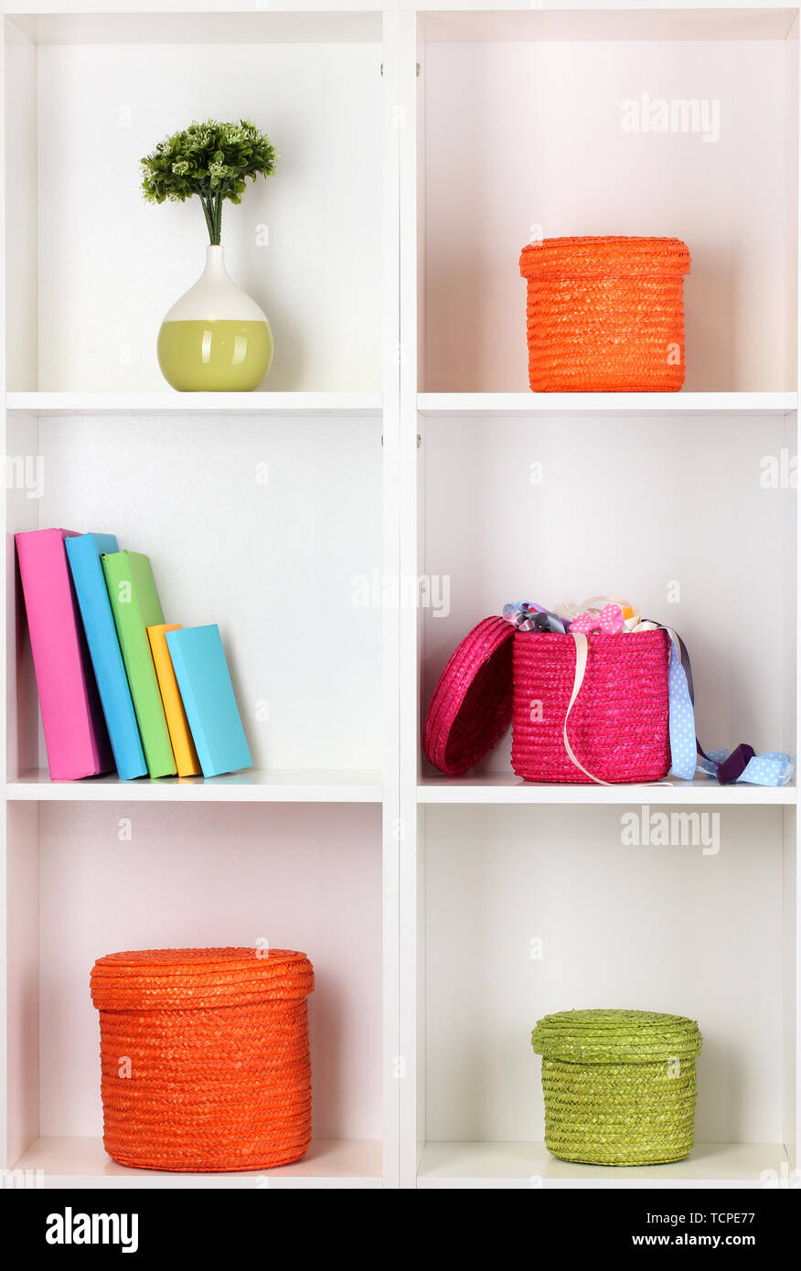Color wicker boxes on cabinet shelves Stock Photo - Alamy