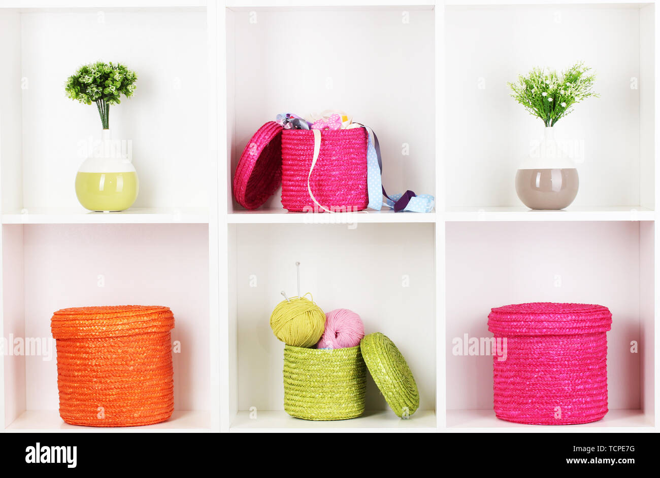 Color wicker boxes on cabinet shelves Stock Photo - Alamy