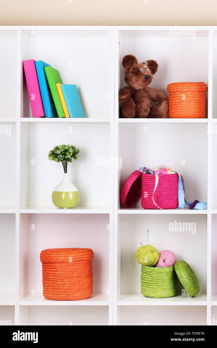 Color wicker boxes on cabinet shelves Stock Photo - Alamy