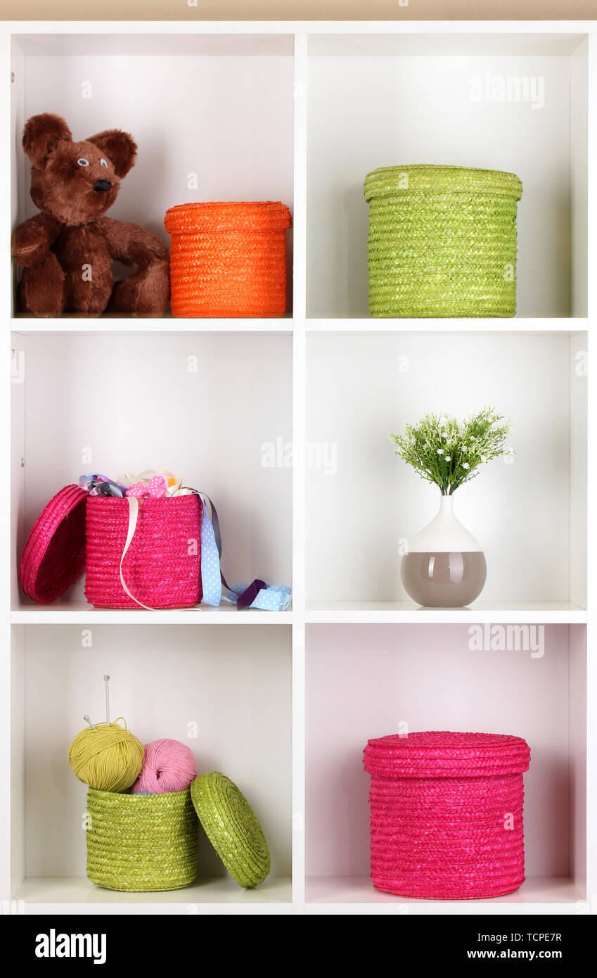 Color wicker boxes on cabinet shelves Stock Photo - Alamy