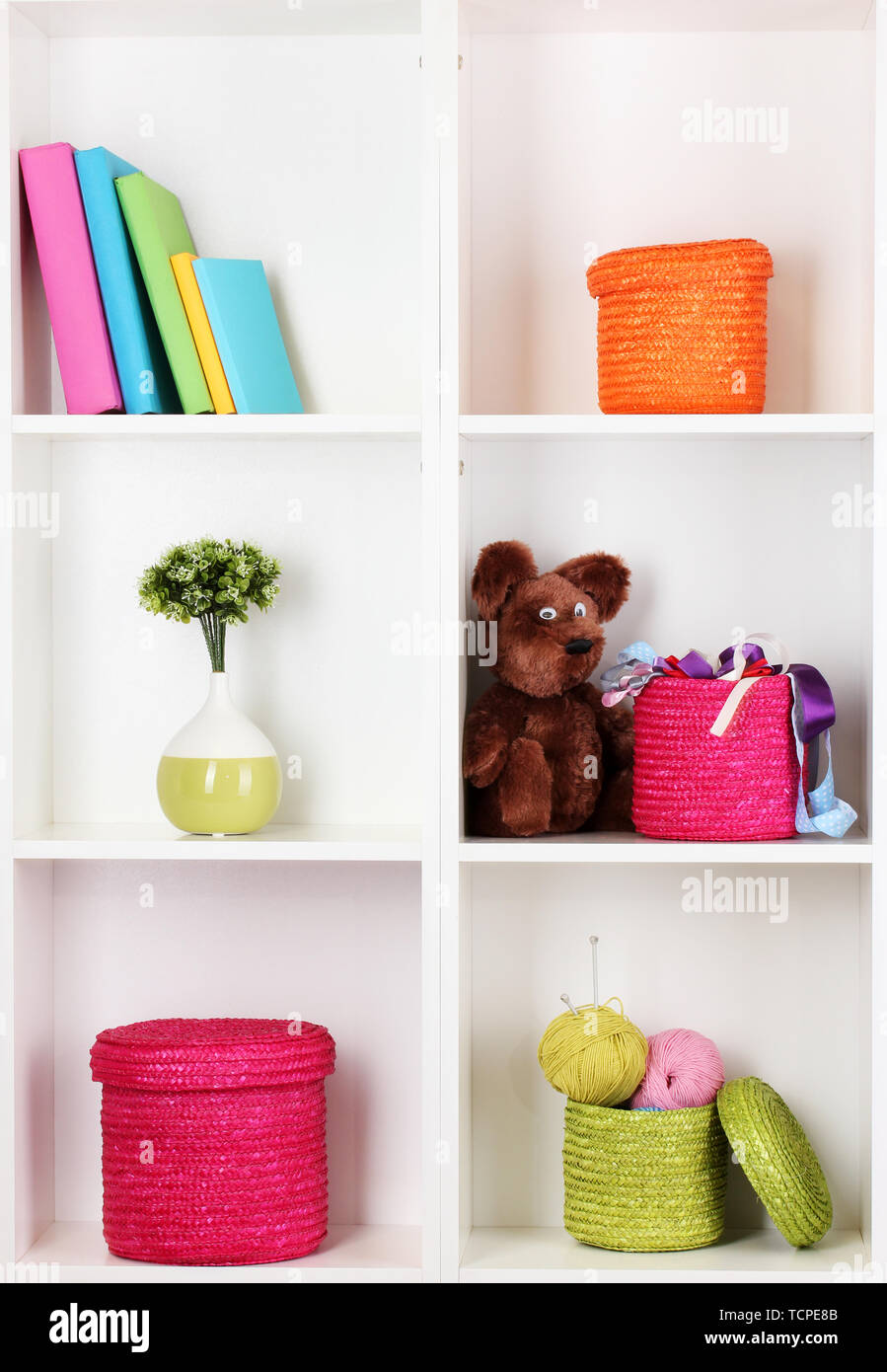 Color wicker boxes on cabinet shelves Stock Photo - Alamy