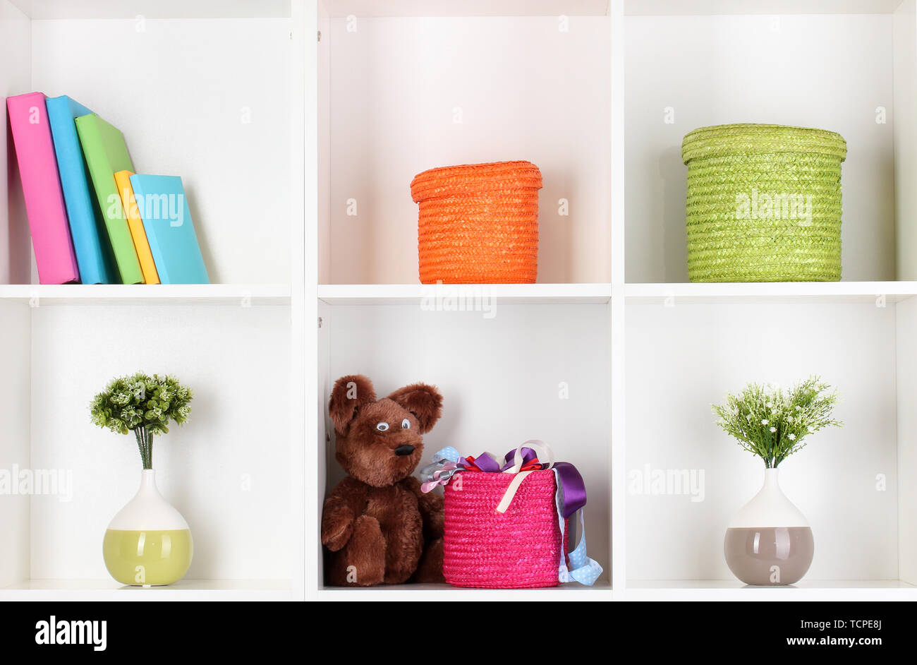 Color wicker boxes on cabinet shelves Stock Photo - Alamy