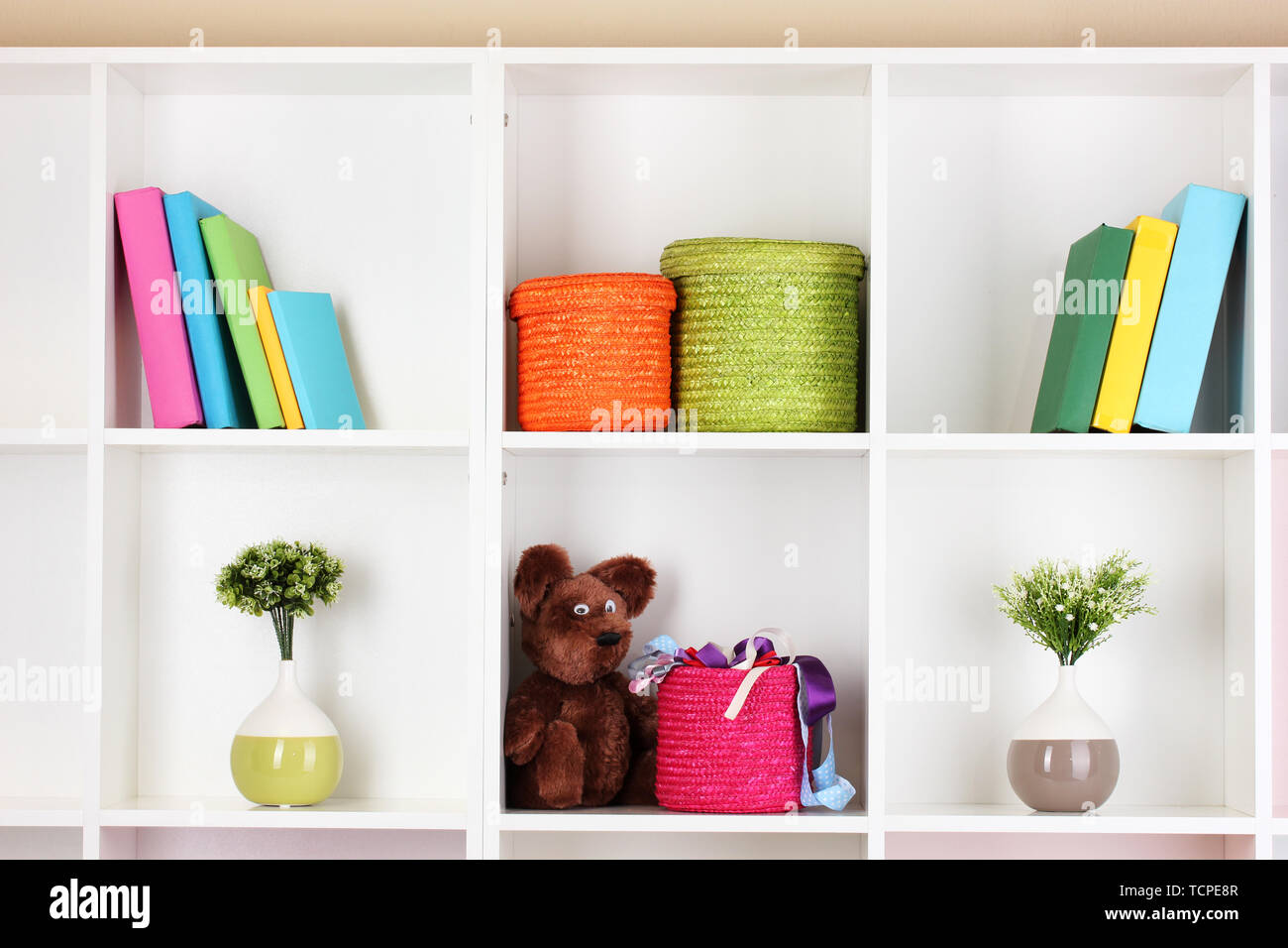 Color wicker boxes on cabinet shelves Stock Photo - Alamy