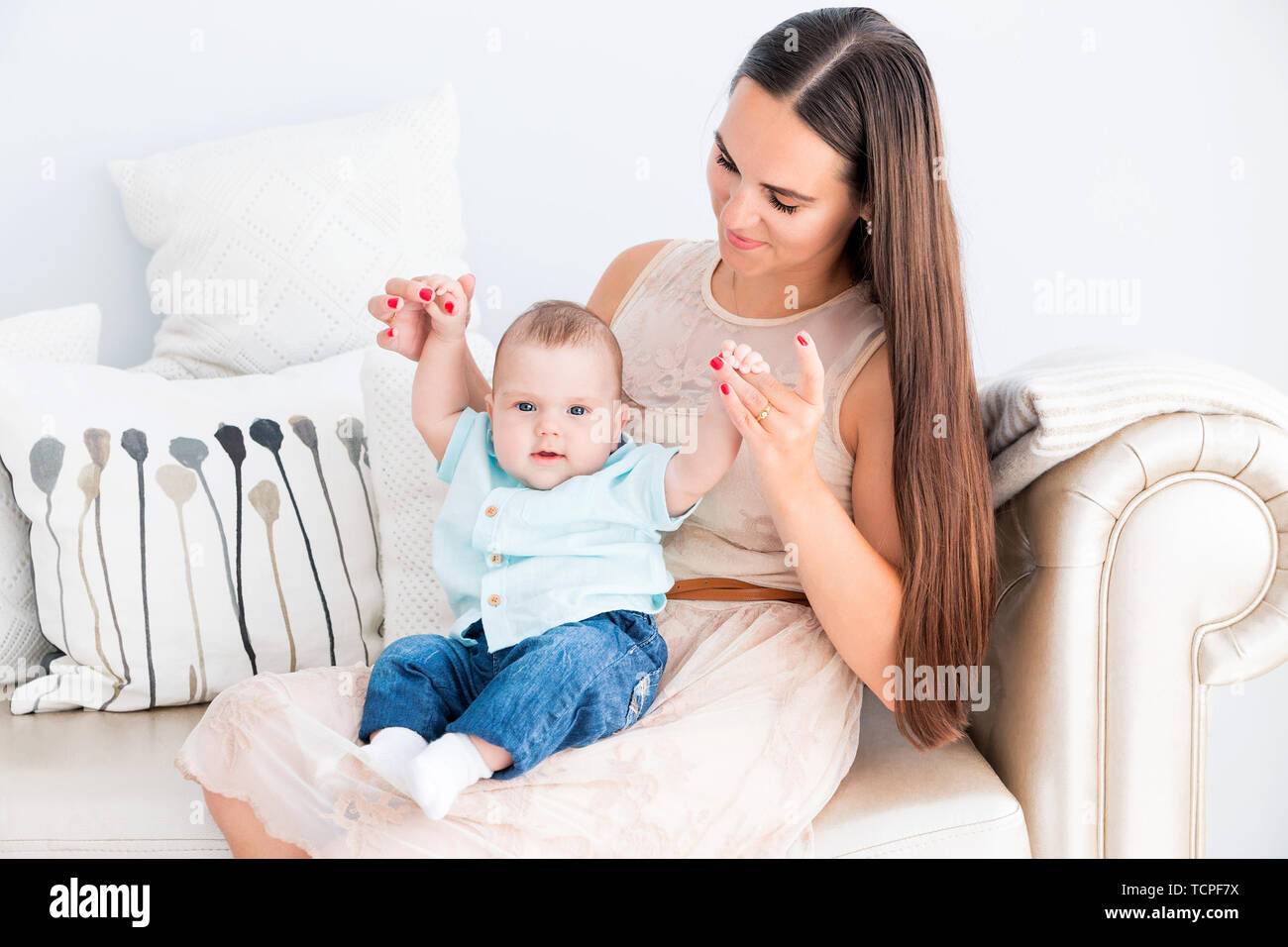 Mom sitting baby on knees hi-res stock photography and images - Alamy