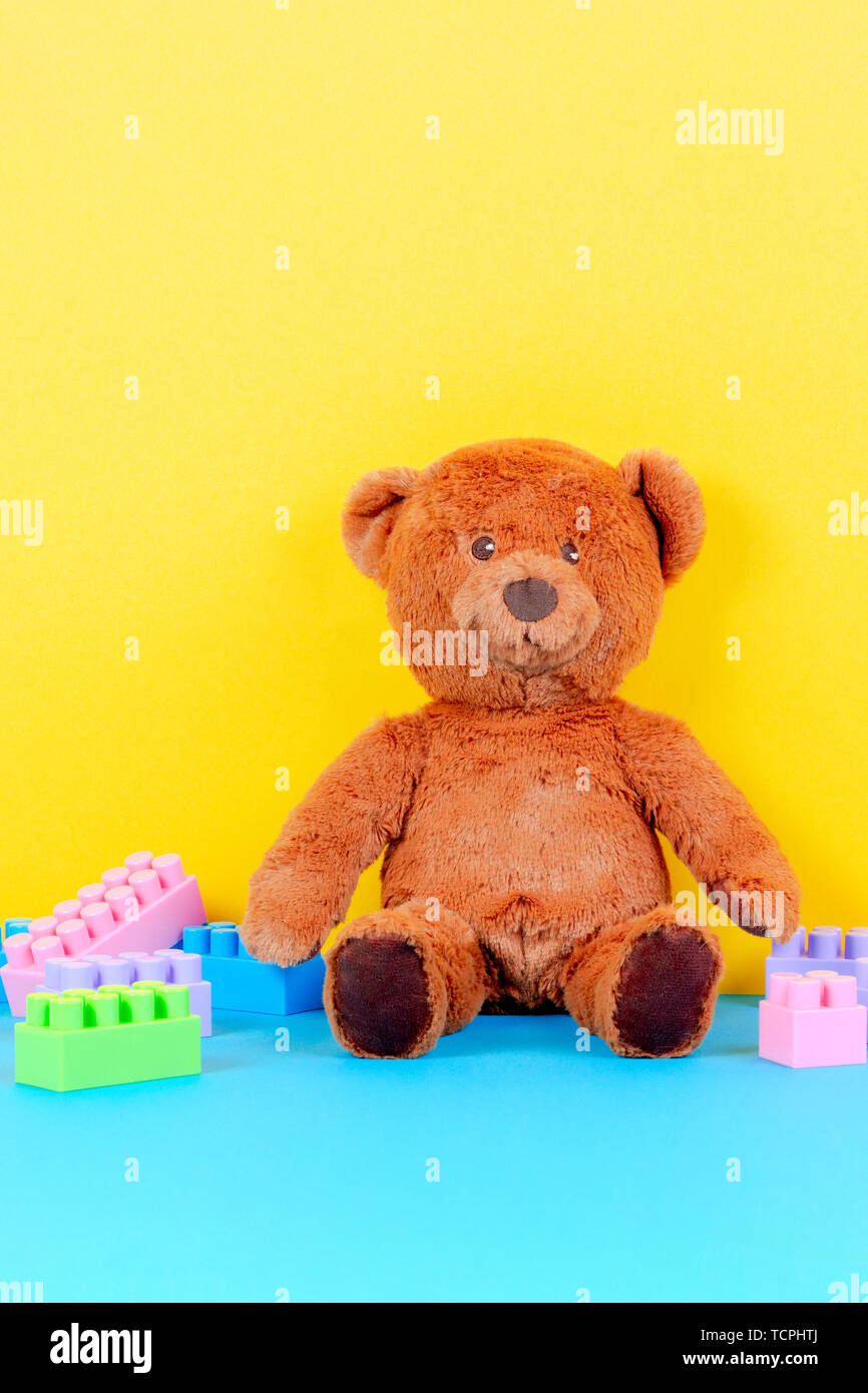 Baby kids toys background with teddy bear and colorful building blocks ...