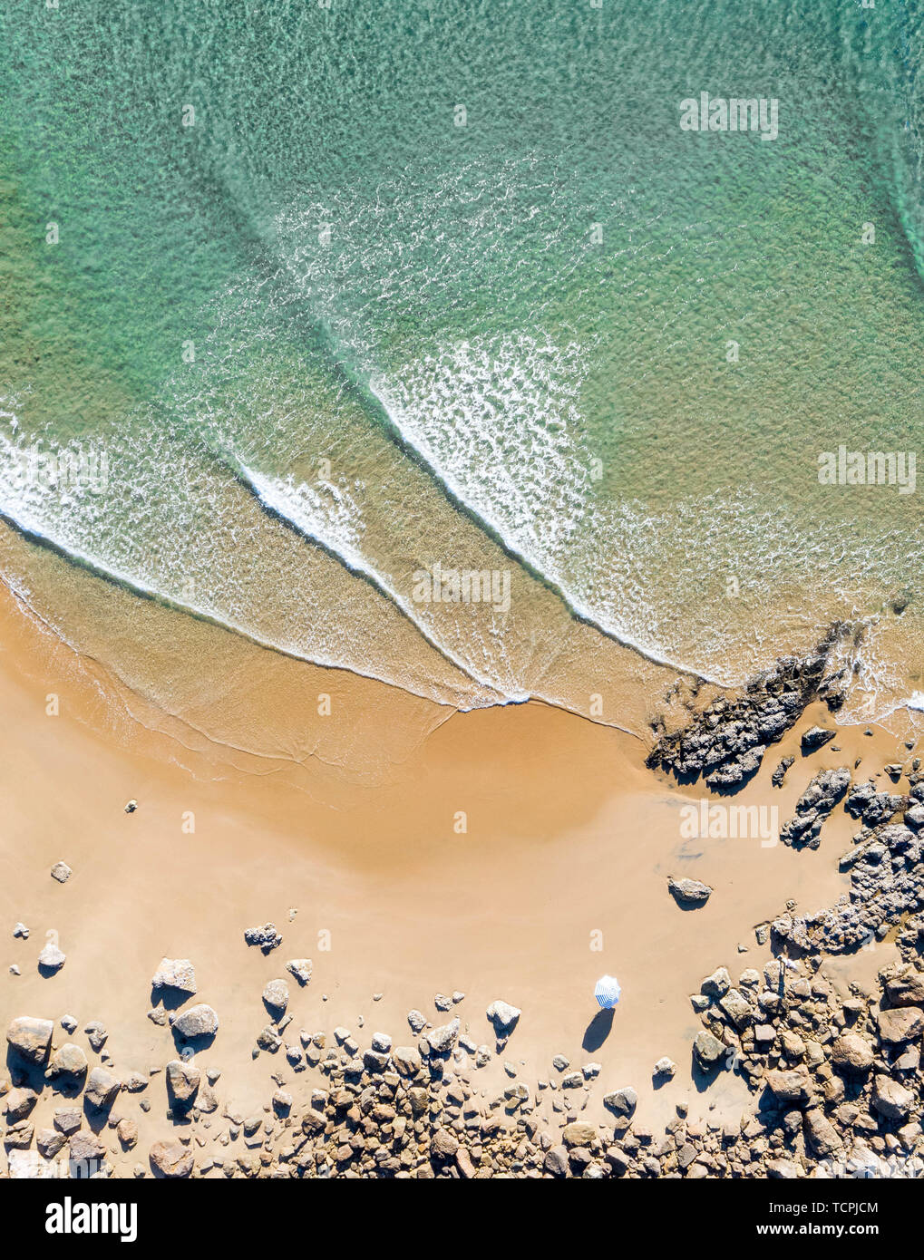 Top beautiful view of a beach at sunrise with beautiful waves lines ...