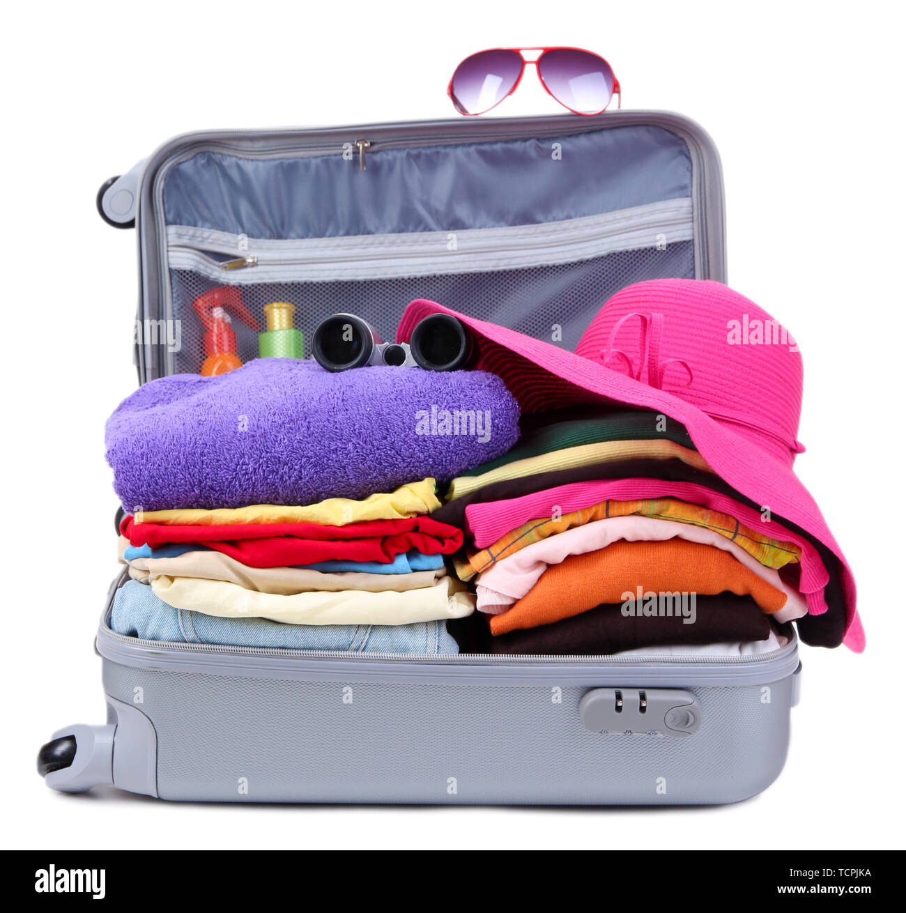 Open silver suitcase with clothing isolated on white Stock Photo - Alamy