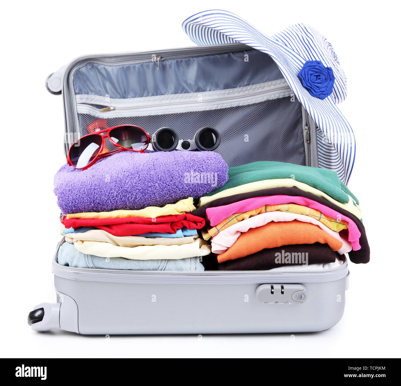Open silver suitcase with clothing isolated on white Stock Photo - Alamy