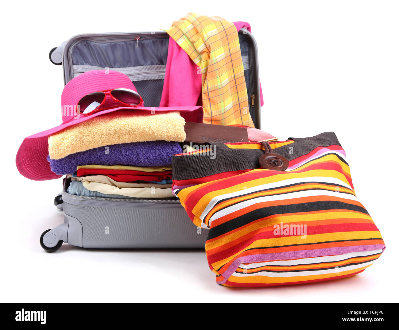 Open silver suitcase with clothing isolated on white Stock Photo - Alamy