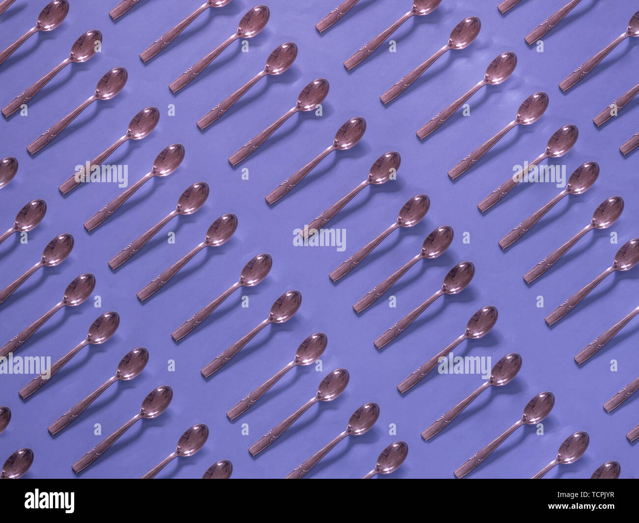 Spoons pattern on purple background Stock Photo - Alamy