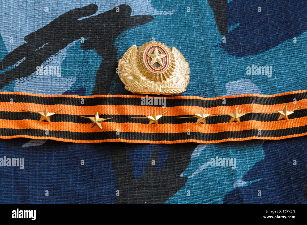 Gold stars, St. George ribbon on blue camouflage fabric. Military ...