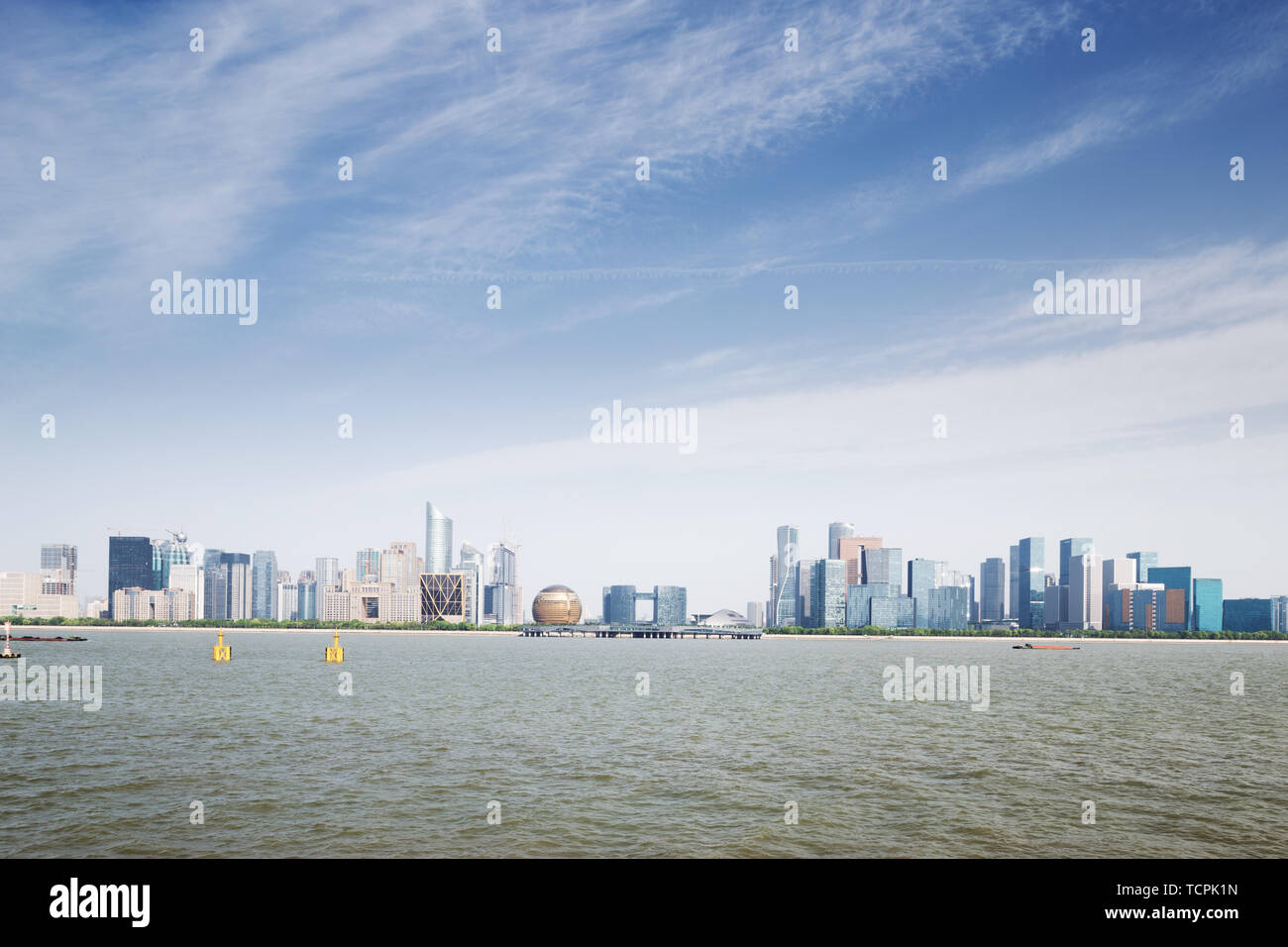 Cityscape of modern city near water Stock Photo - Alamy