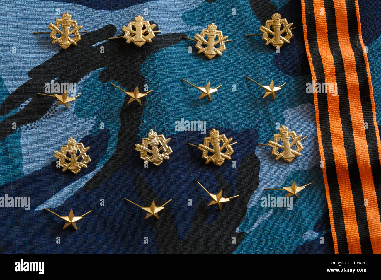 Gold stars, St. George ribbon on blue camouflage fabric. Military ...