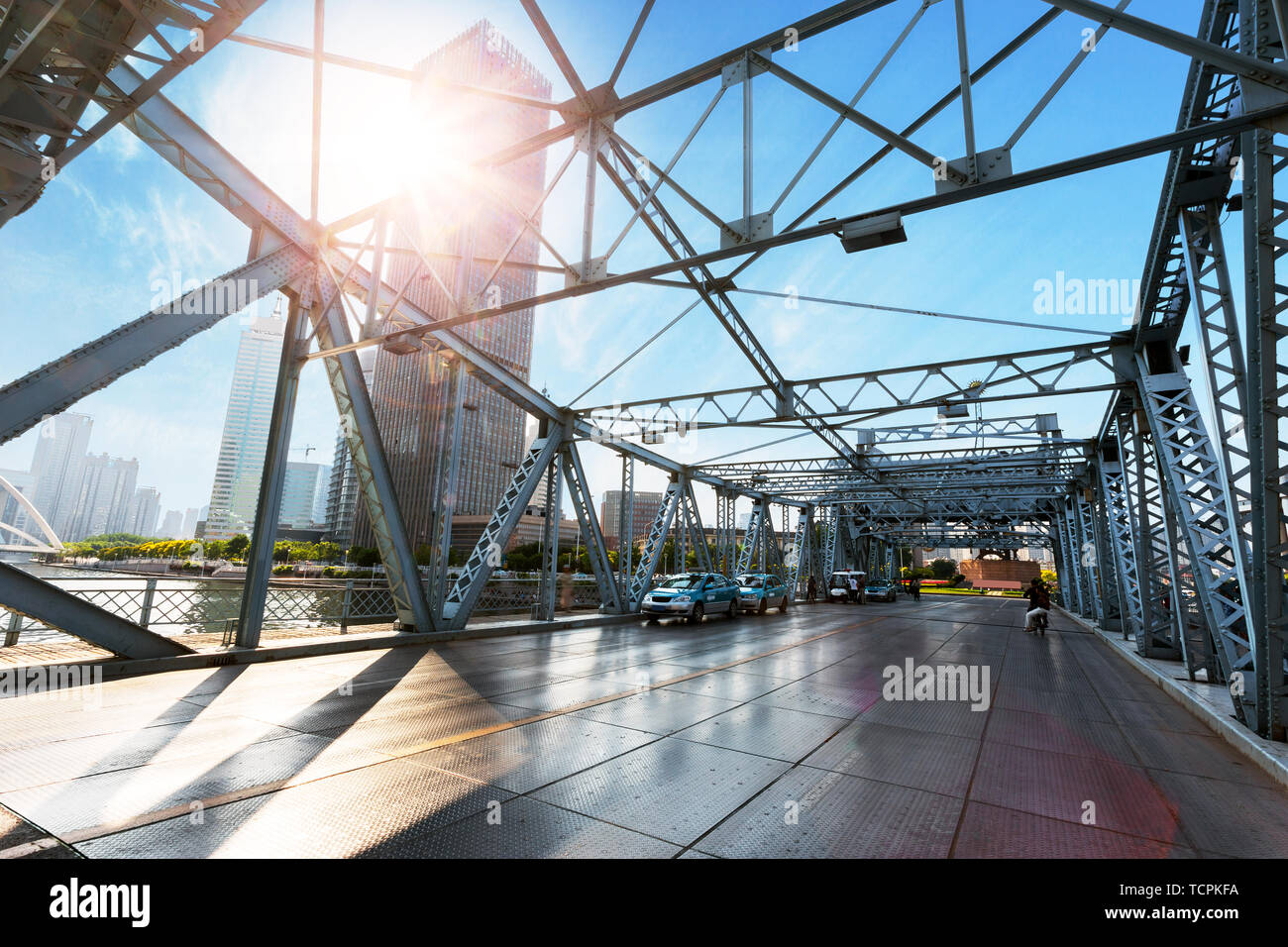 Traffic on steel bridge interior and skyline at sunset Stock Photo - Alamy