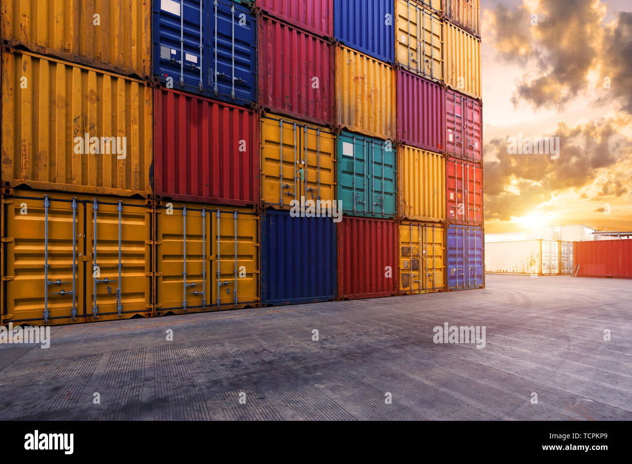 stack of containers with empty road in front Stock Photo - Alamy