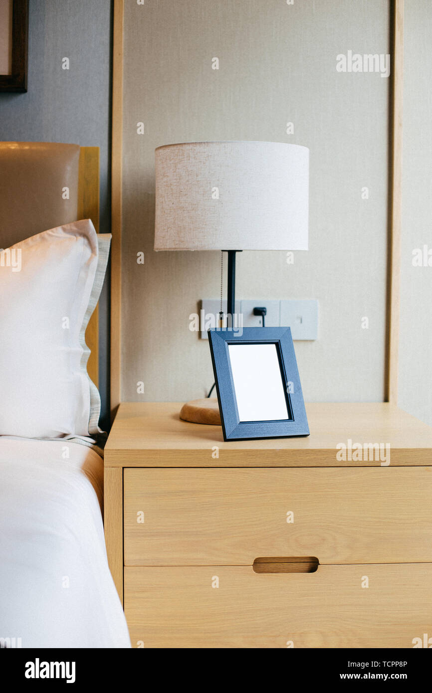 night table with frame in modern bedroom Stock Photo - Alamy