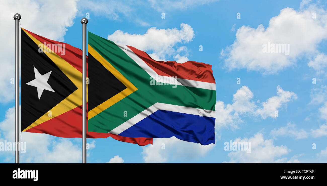 East Timor and South Africa flag waving in the wind against white ...
