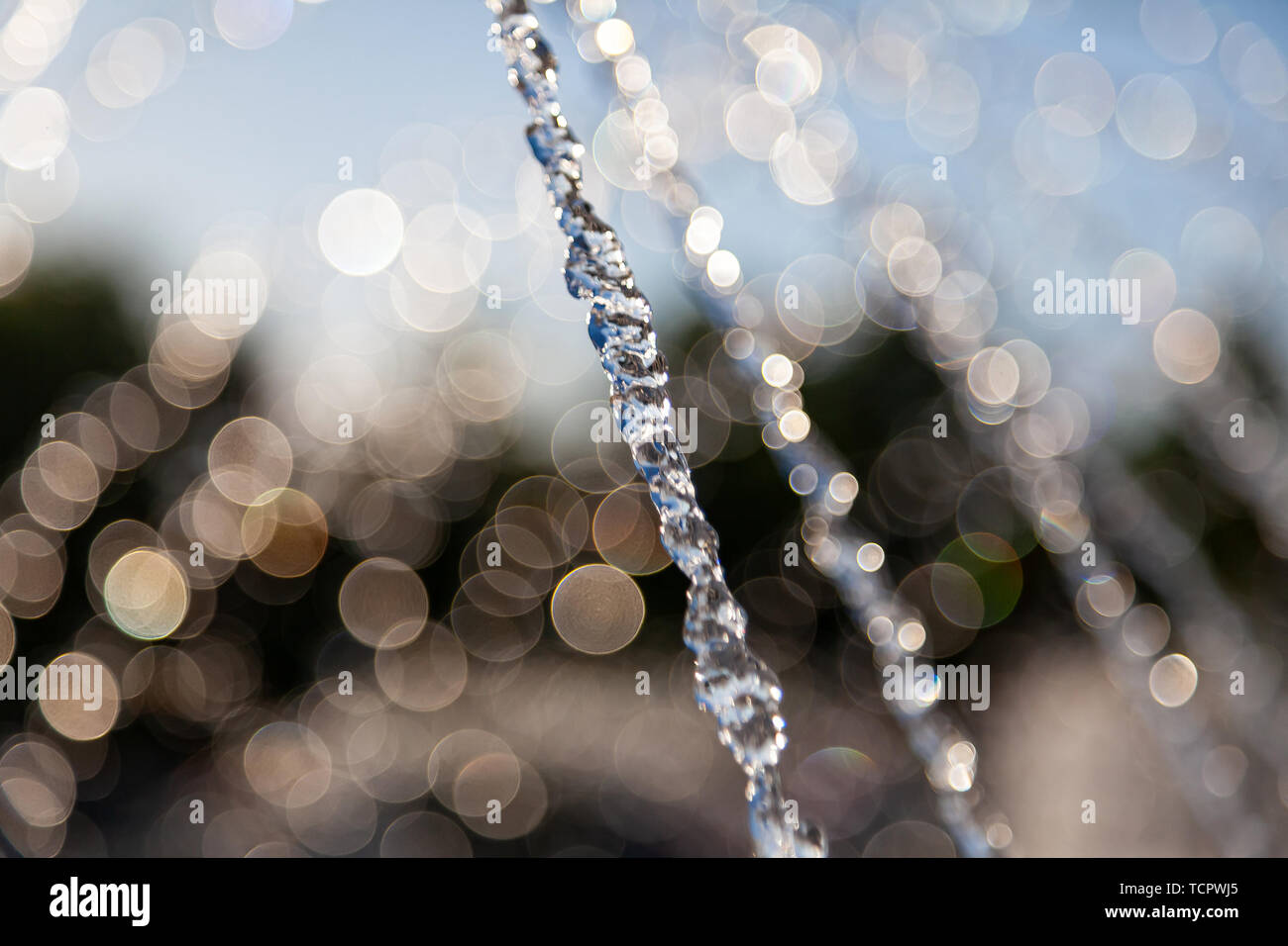 A jet of water from the fountain in a frozen position pouring upward ...