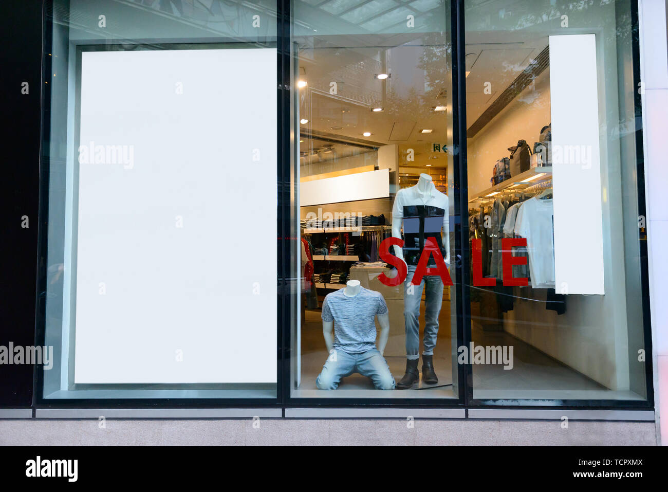 Sale word on shopfront display window Stock Photo - Alamy