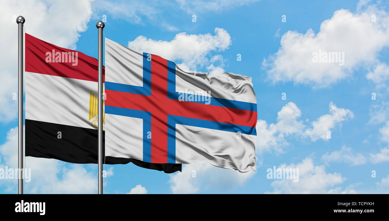 Egypt and Faroe Islands flag waving in the wind against white cloudy ...