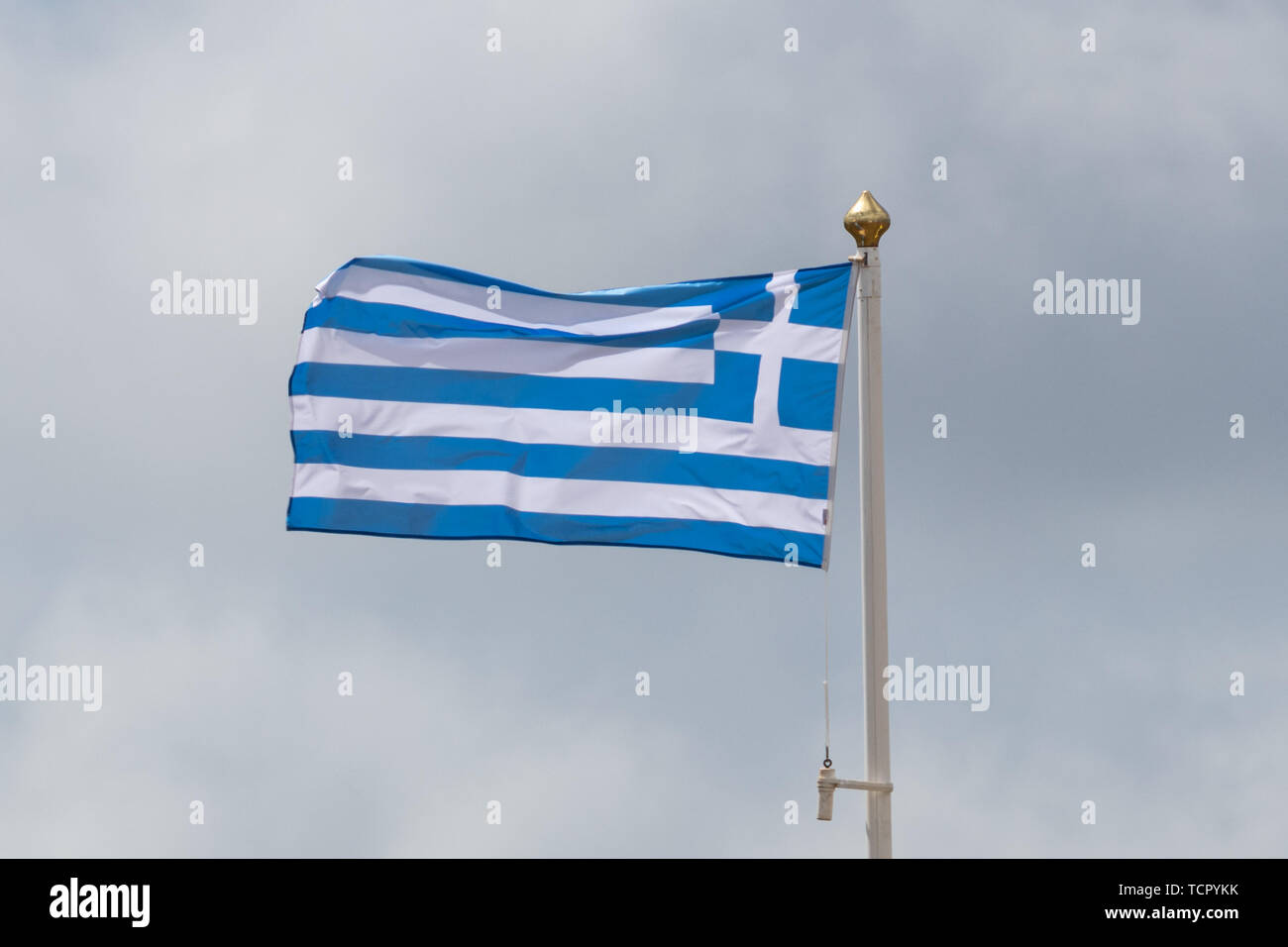 A Greek flag flying on a flag pole Stock Photo - Alamy