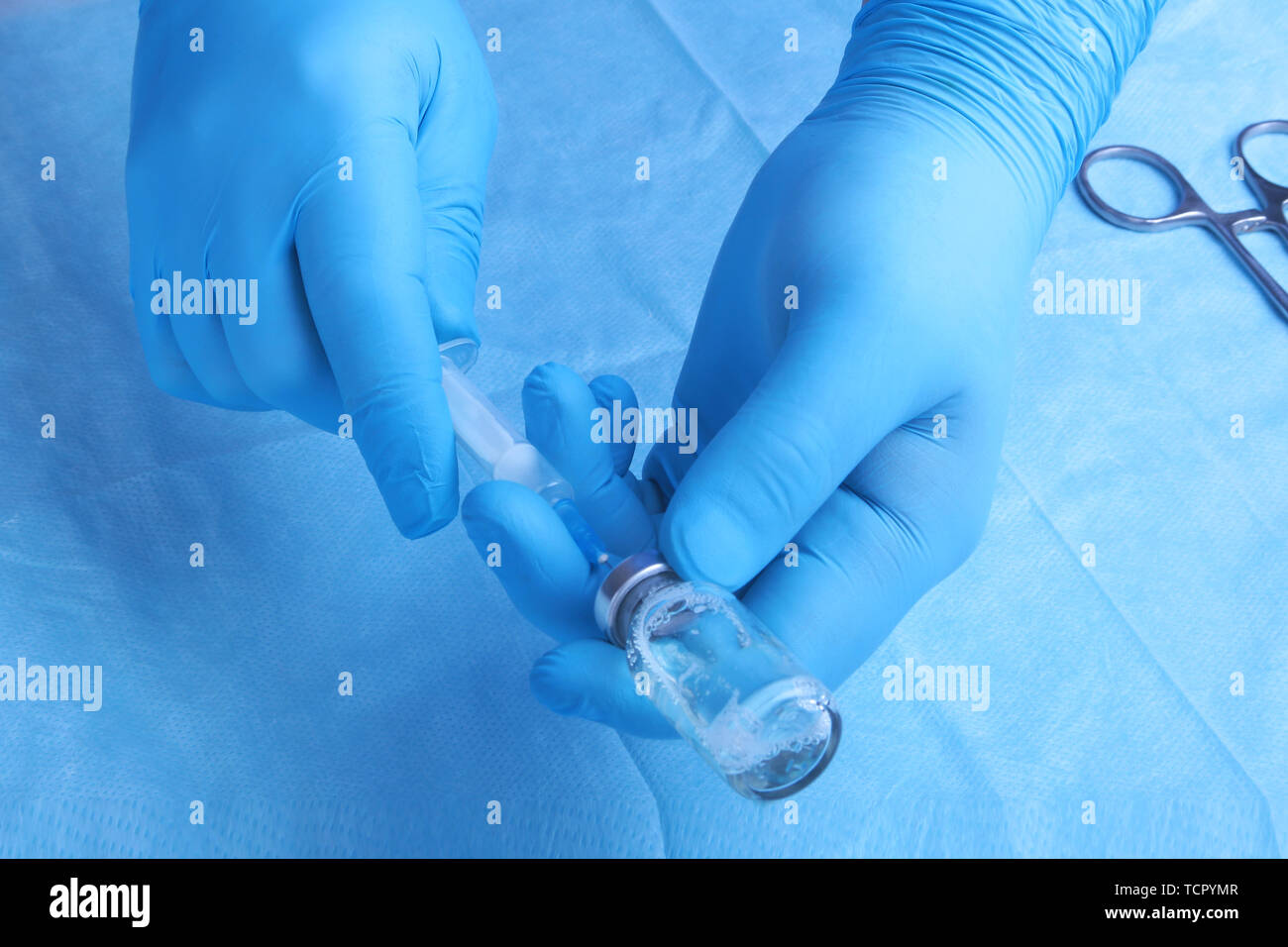 Syringe, medical injection, bottle, ampule in hand, palm or fingers ...