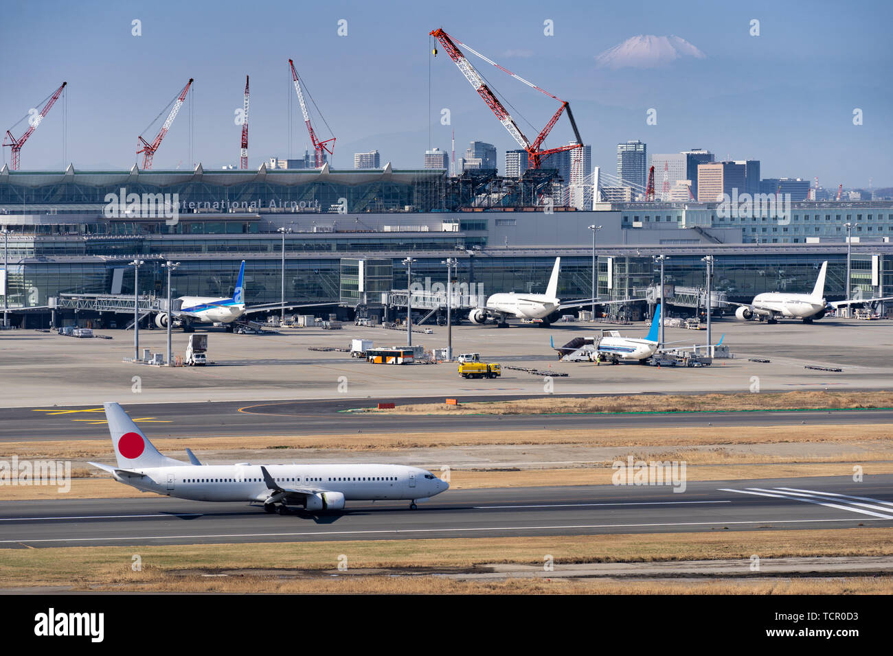Airplane taxi in runway with airport teminal in background Stock Photo ...