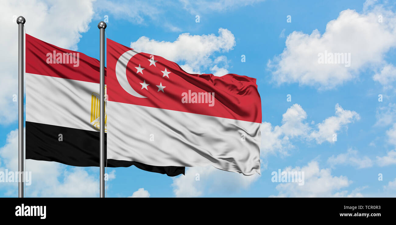 Egypt and Singapore flag waving in the wind against white cloudy blue ...