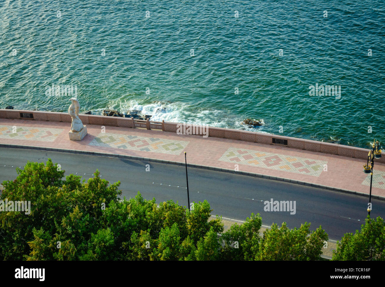 Coastal Road with pattern tiled pavement and a fish statue from Muttrah ...