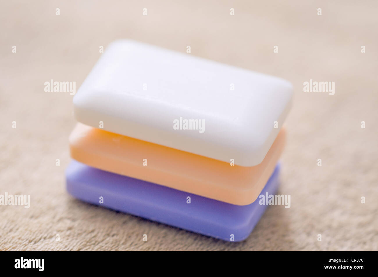 Three bars of soap on a pale brown towel Stock Photo - Alamy