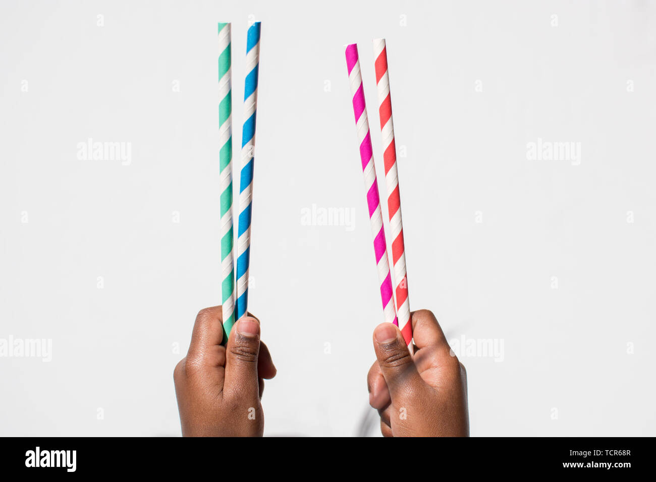 A young girl holding paper straw which is an alternative to plastic ...