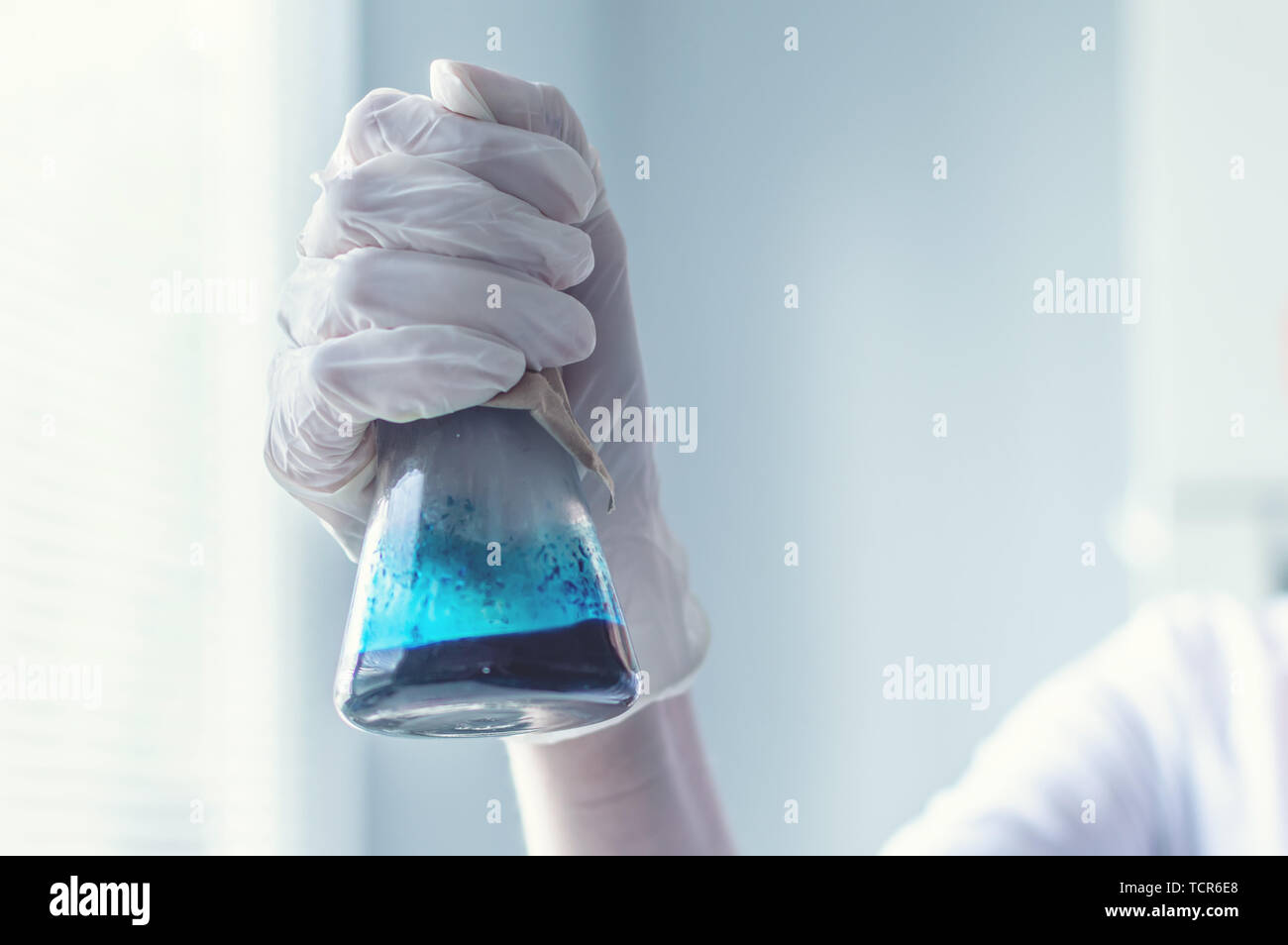 hands with test tubes in the laboratory to study viruses and microbes ...