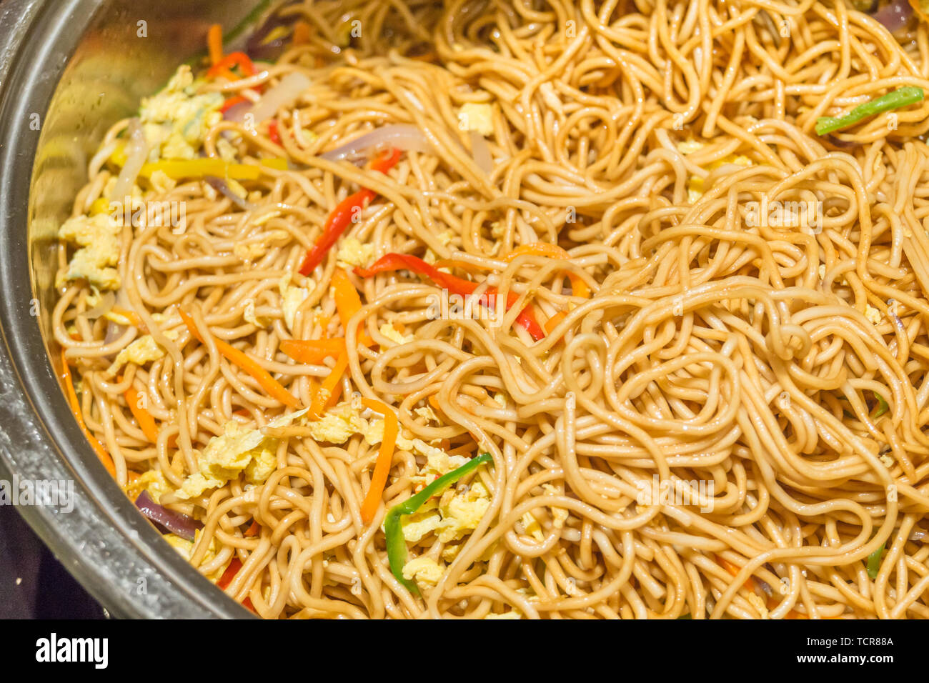 A big pot of fried noodles close-up Stock Photo - Alamy