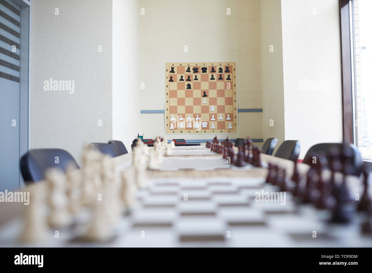 Chess classroom at school with chess poster on wall and long table with ...